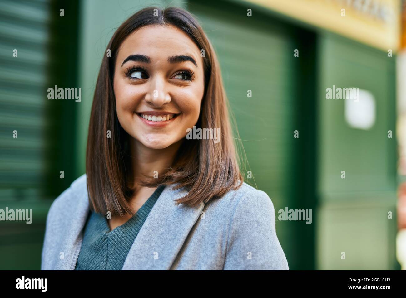 Young hispanic girl smiling happy standing at the city Stock Photo - Alamy