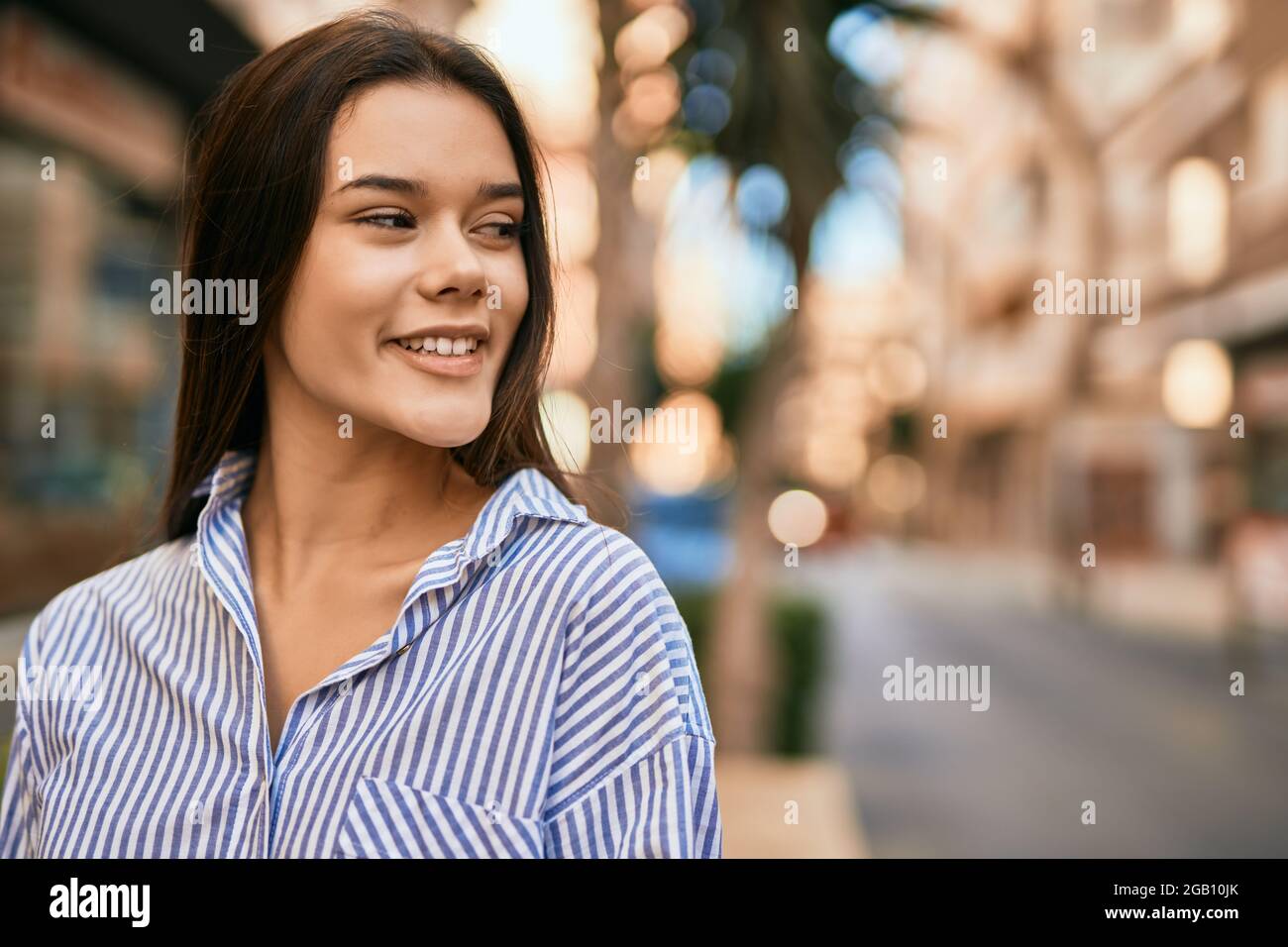 Young hispanic girl smiling happy standing at the city Stock Photo - Alamy