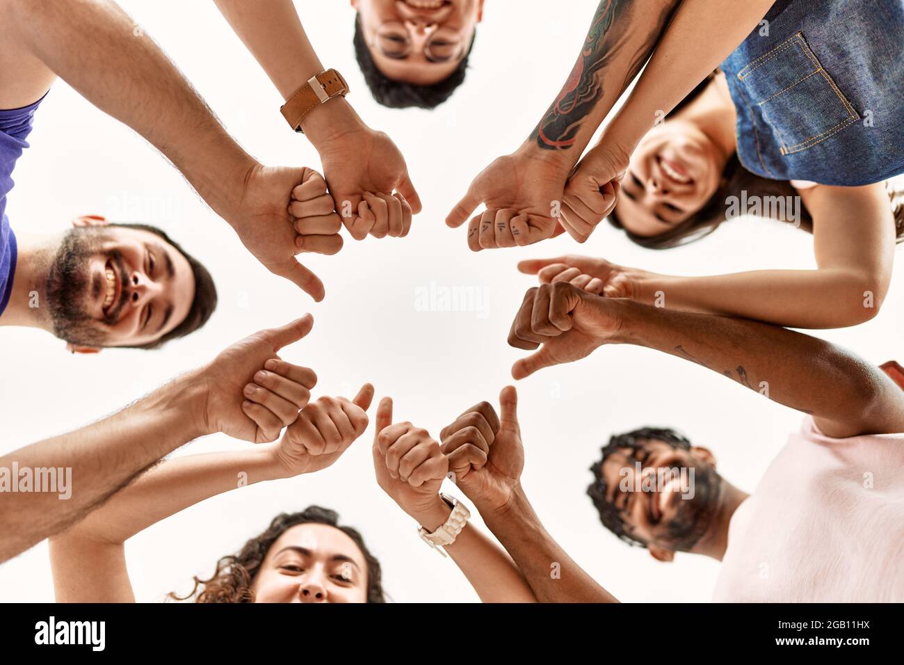 Group of young friends with hands together Stock Photo - Alamy