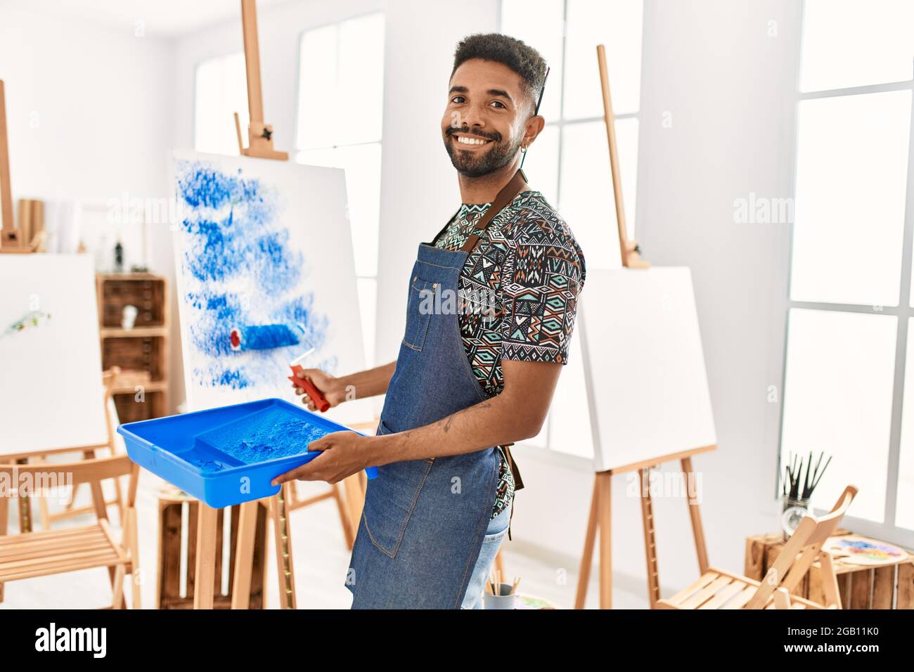 Young african american artist man smiling happy painting with paint ...