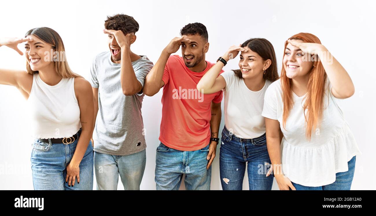 Group of young friends standing together over isolated background very ...