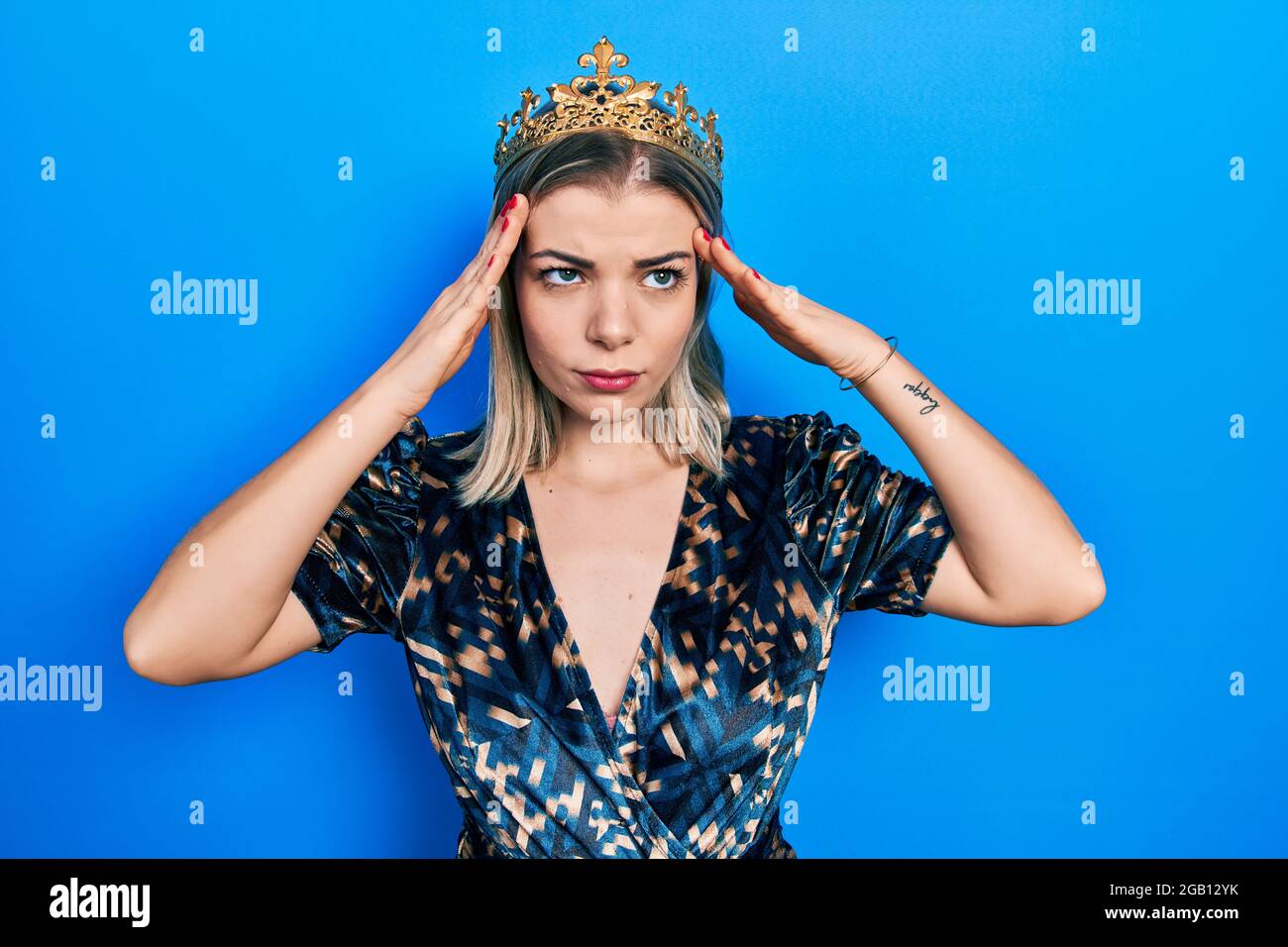 Beautiful caucasian woman wearing princess crown suffering from ...