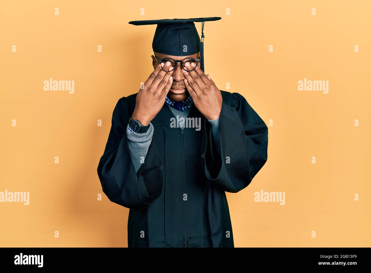 Young african american man wearing graduation cap and ceremony robe ...