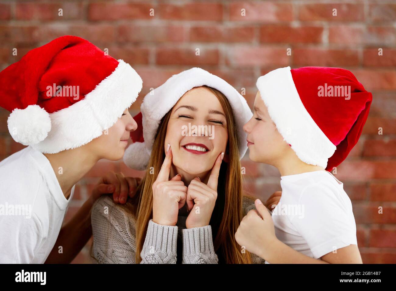 Happy cousins on brick wall background Stock Photo - Alamy