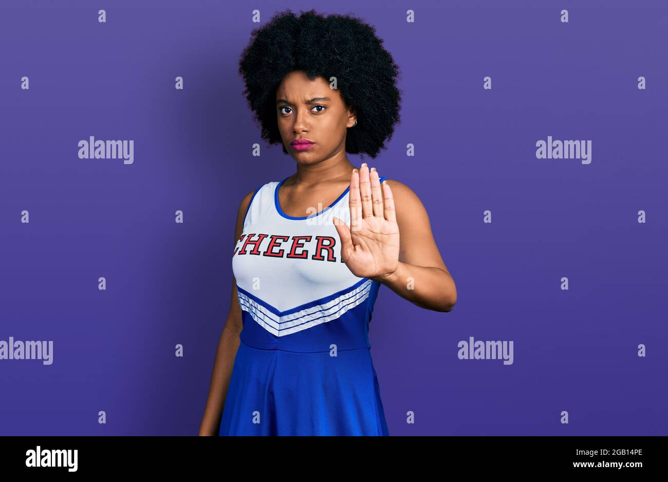 Young african american woman wearing cheerleader uniform doing stop ...