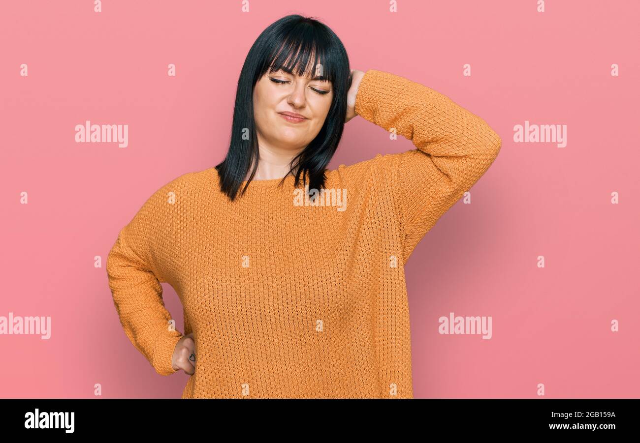 Young hispanic woman wearing casual clothes suffering of neck ache ...
