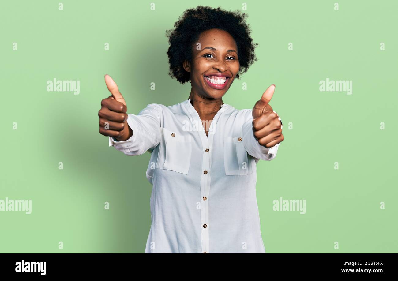 African american woman with afro hair wearing casual white t shirt ...