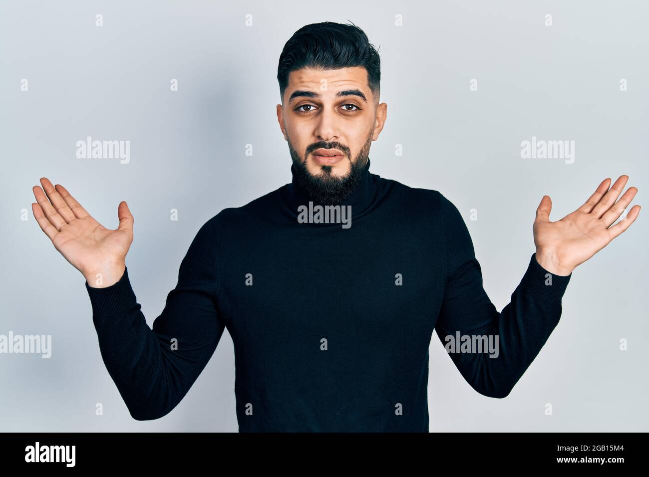 Handsome man with beard wearing turtleneck sweater clueless and ...