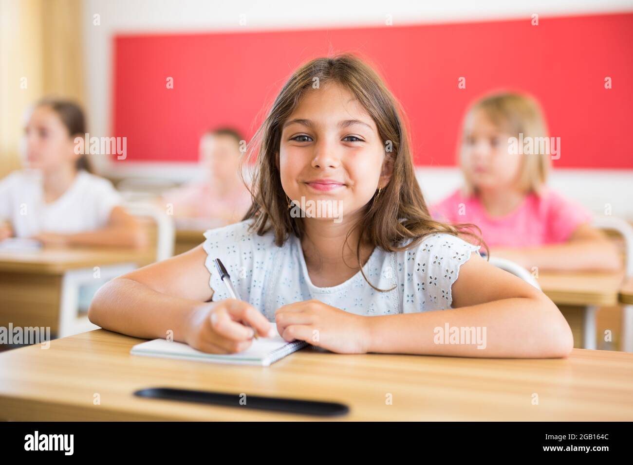 Young girl in classroom Stock Photo - Alamy