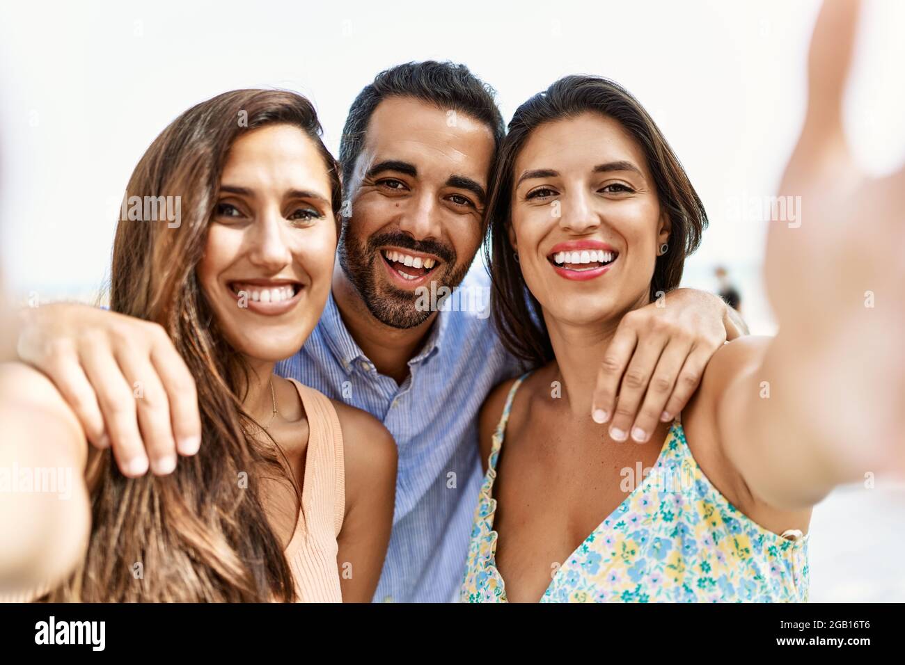 Three young hispanic friends smiling happy and hugging make selfie by ...