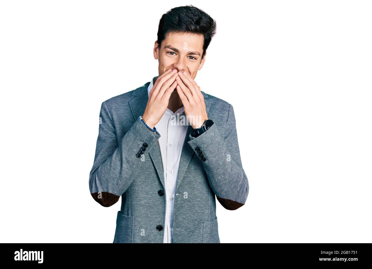 Young hispanic man wearing business clothes laughing and embarrassed ...