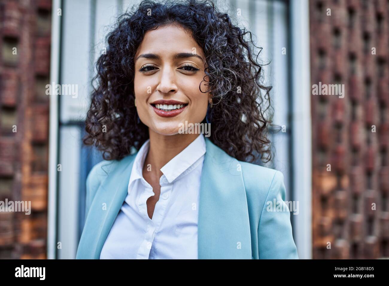 Young hispanic business woman wearing professional look smiling ...