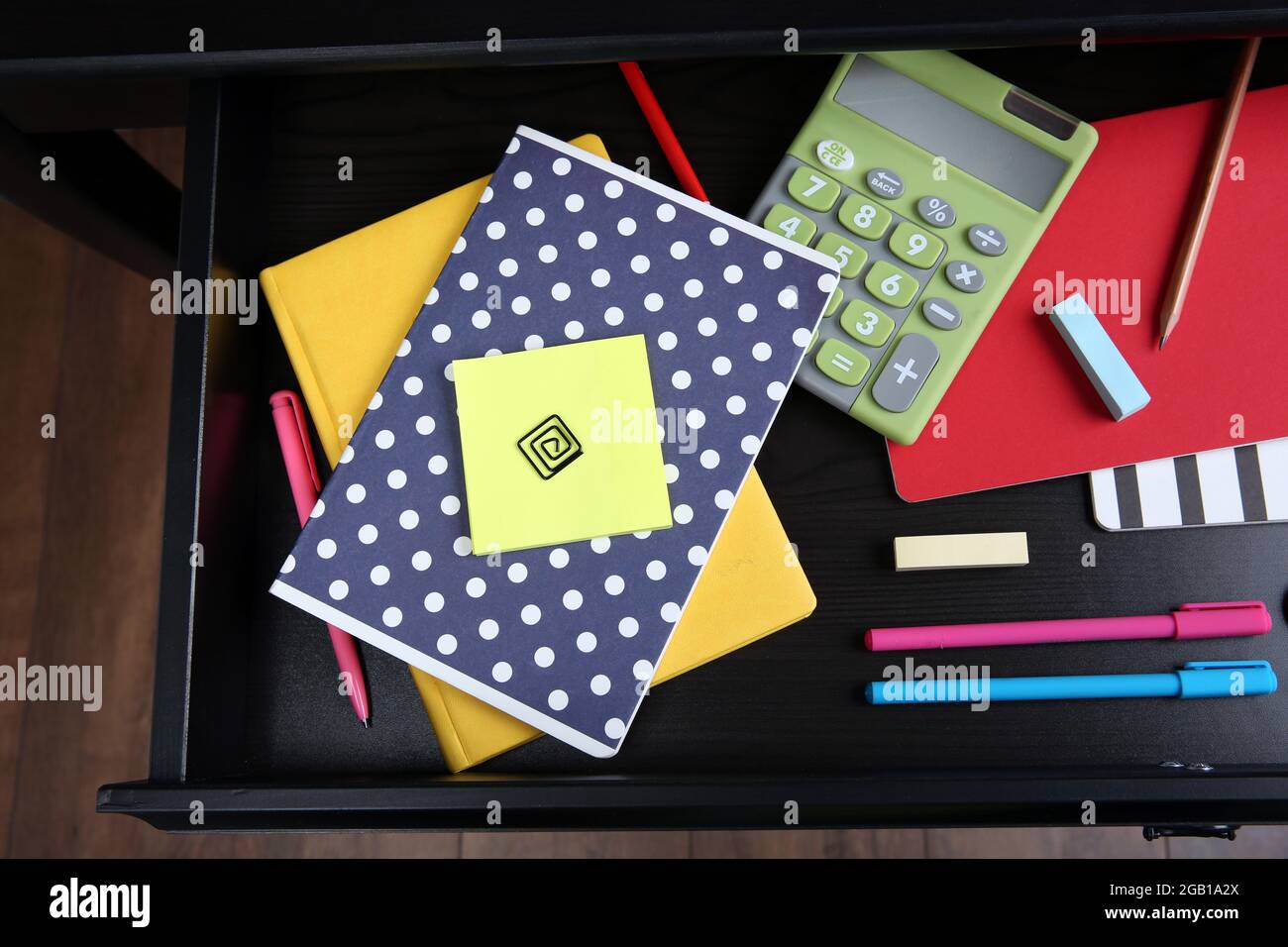 Stationery in open desk drawer, top view Stock Photo - Alamy