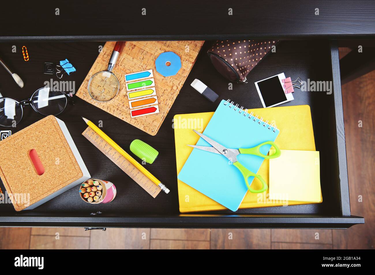 Stationery in open desk drawer, top view Stock Photo - Alamy