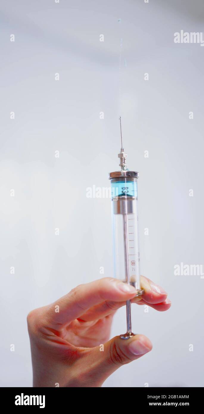 A vertical photo of a syringe Stock Photo - Alamy