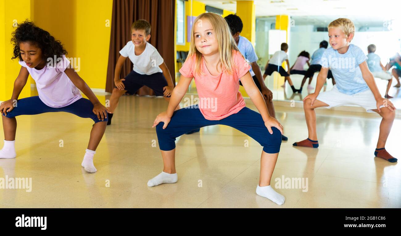 Portrait of smiling children practicing sport dance in modern dance ...