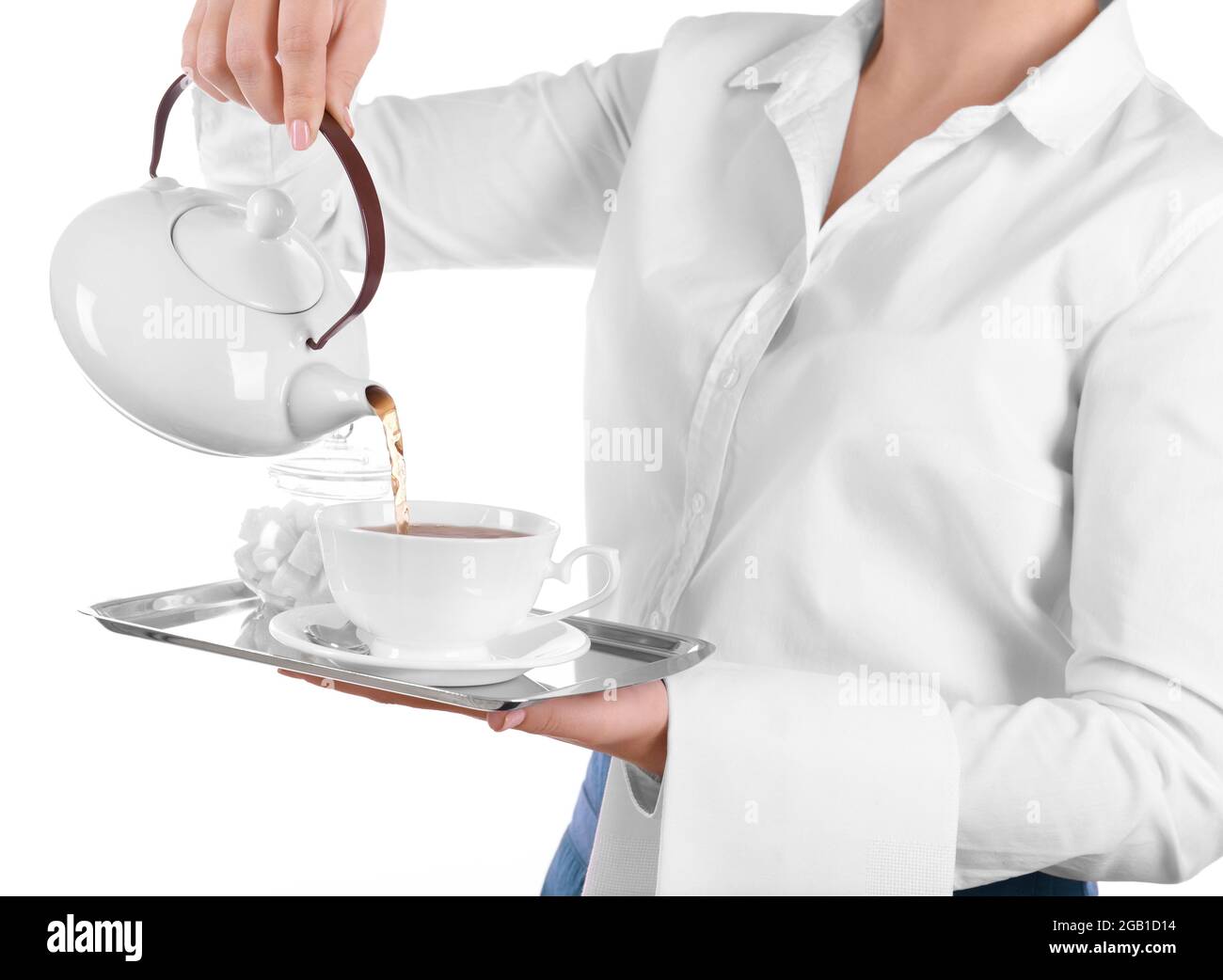 Waiter pouring tea into cup on white background Stock Photo - Alamy