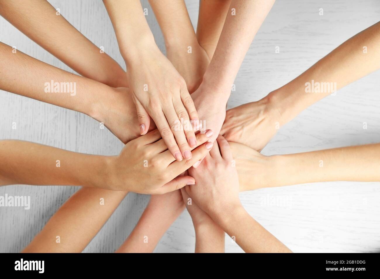 Group of people putting their hands together on wooden background Stock ...