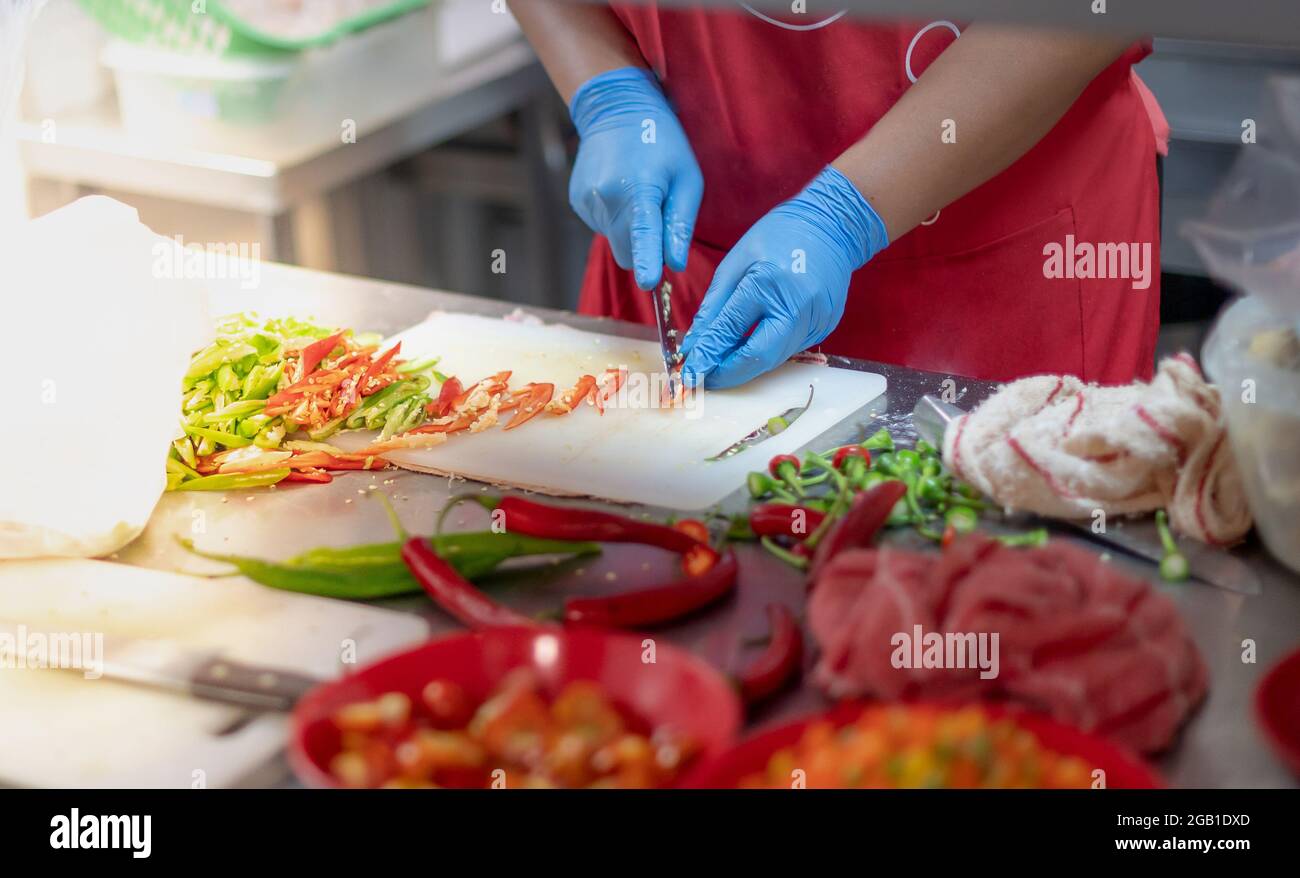 Chef cutting chili for prepare raw material for cooking the lunchbox ...