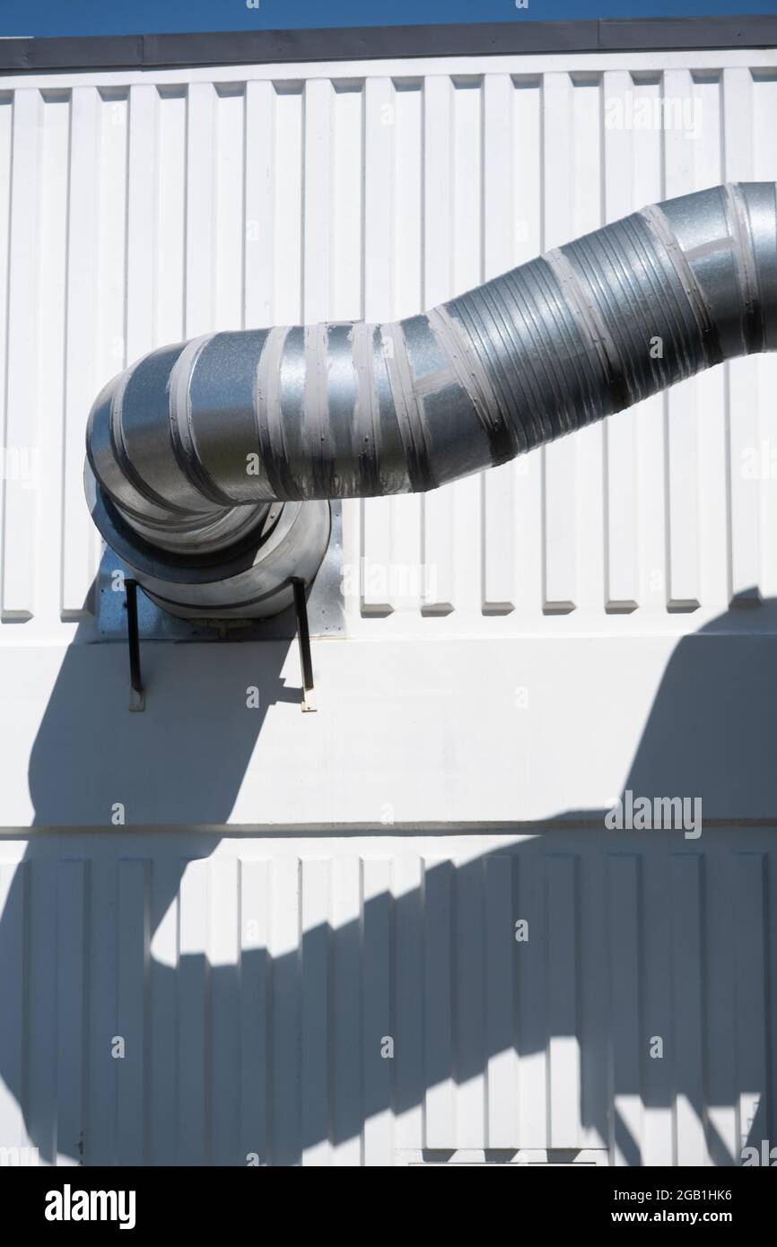 Factory air ventilation pipes on outside of a factory building Stock ...
