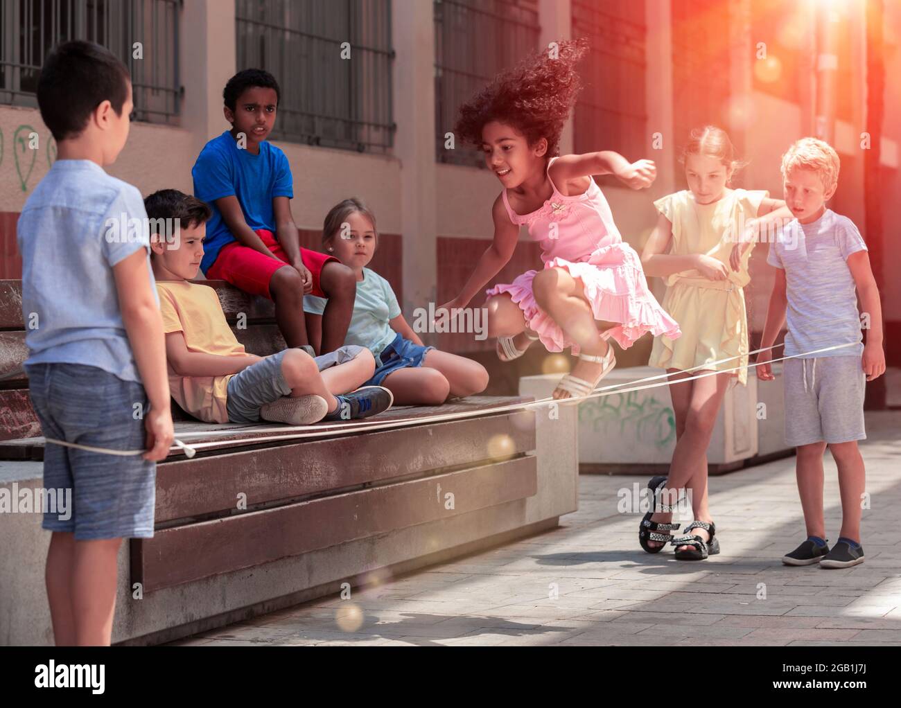 Peruvian little girl jumping game by rubber band with european friends ...