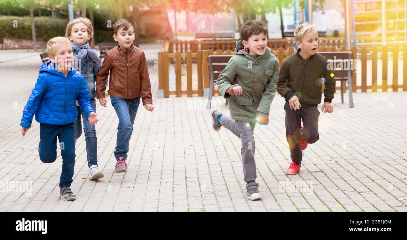 Smiling children playing romp game Touch-last Stock Photo - Alamy
