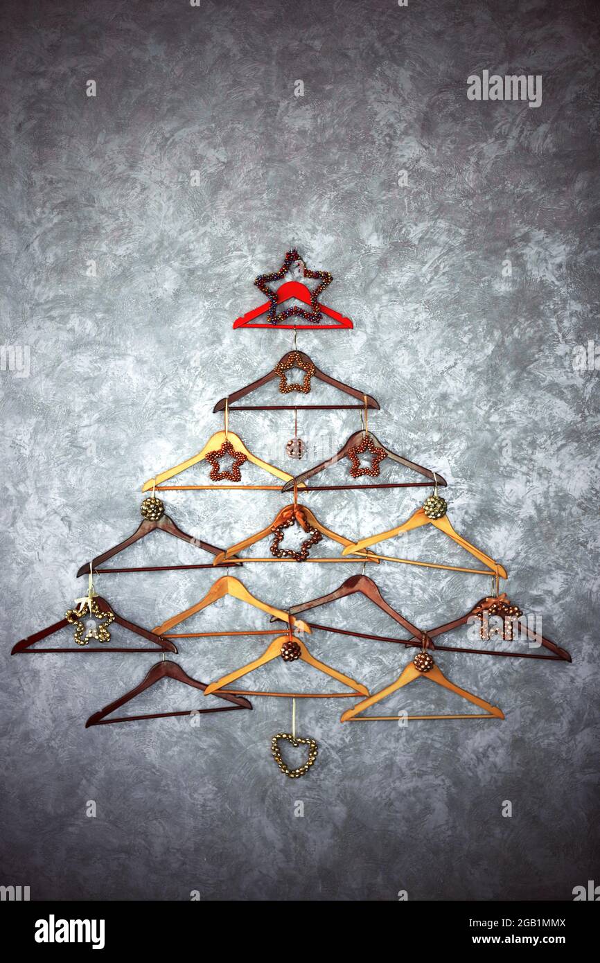 Christmas tree made of hangers on the wall Stock Photo - Alamy