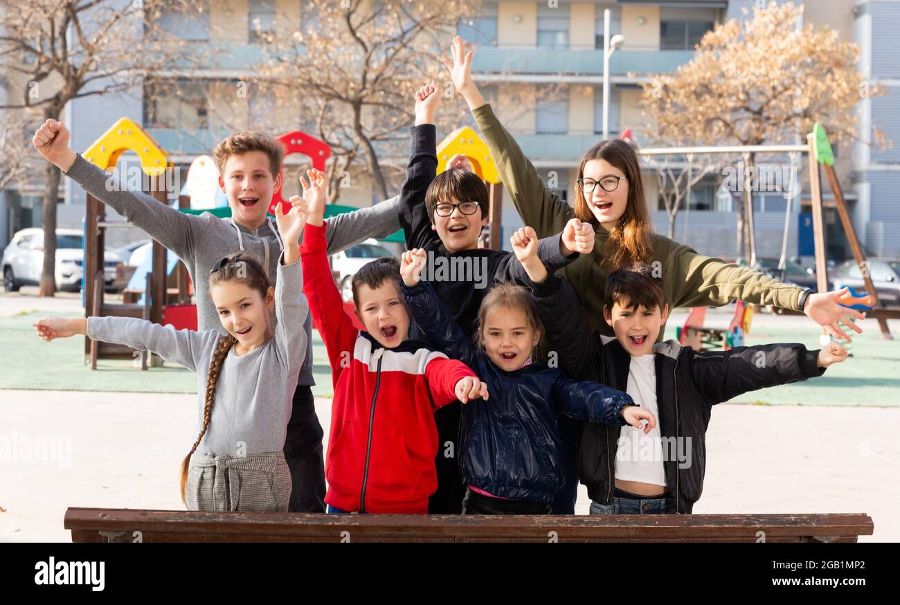 Portrait of happy kids standing together on playground in spring day ...