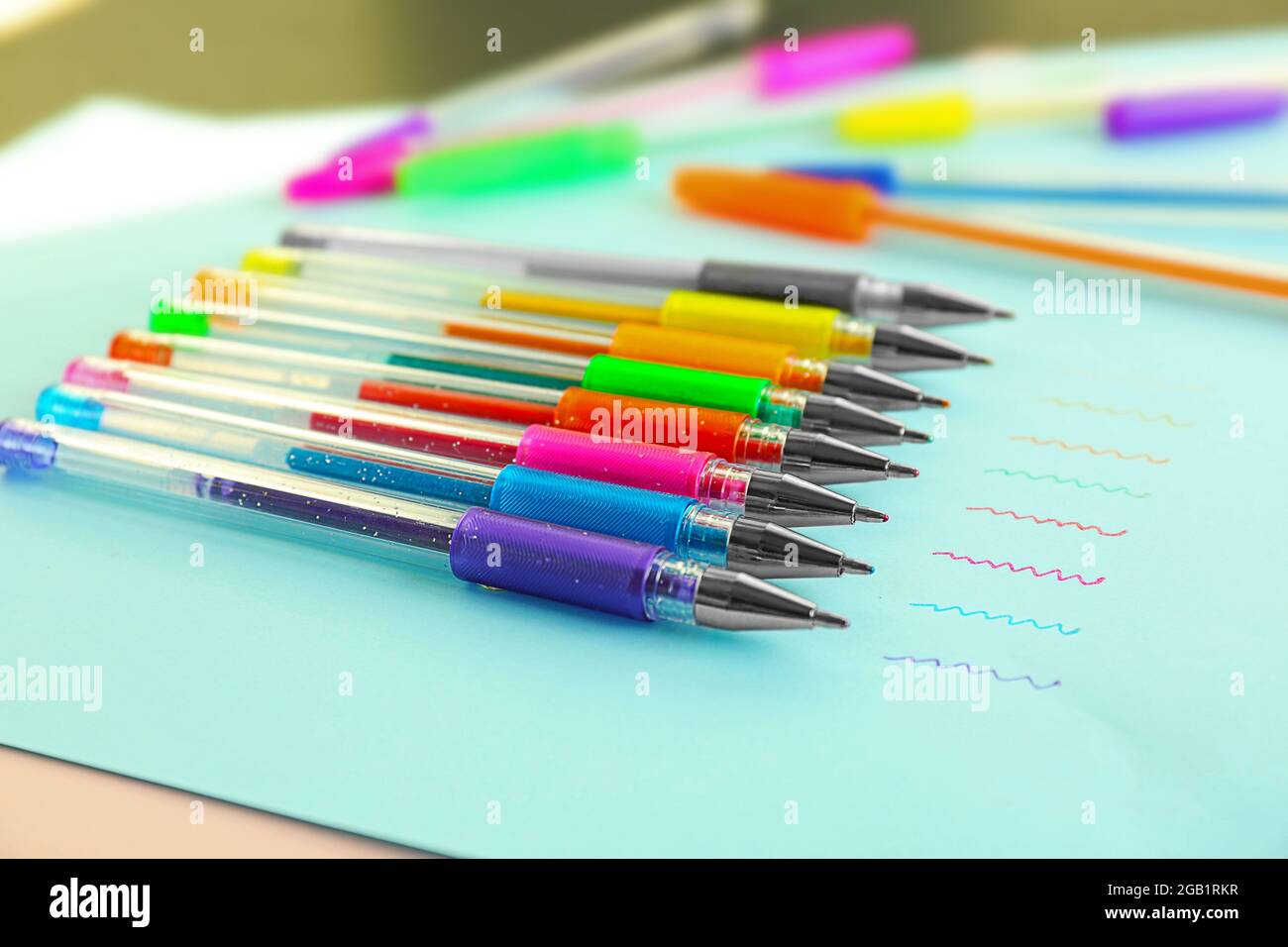 Set of colored pens on blue paper Stock Photo - Alamy