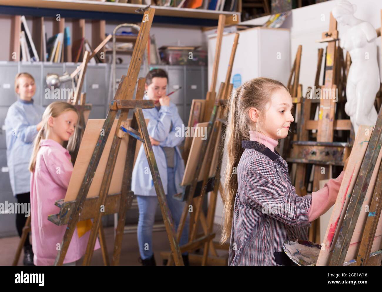 schoolgirls diligently training their painting skills during class at ...