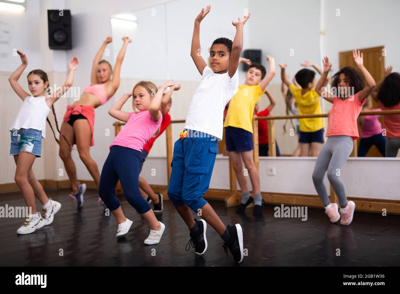 Group of children participating in dance class with teacher Stock Photo ...
