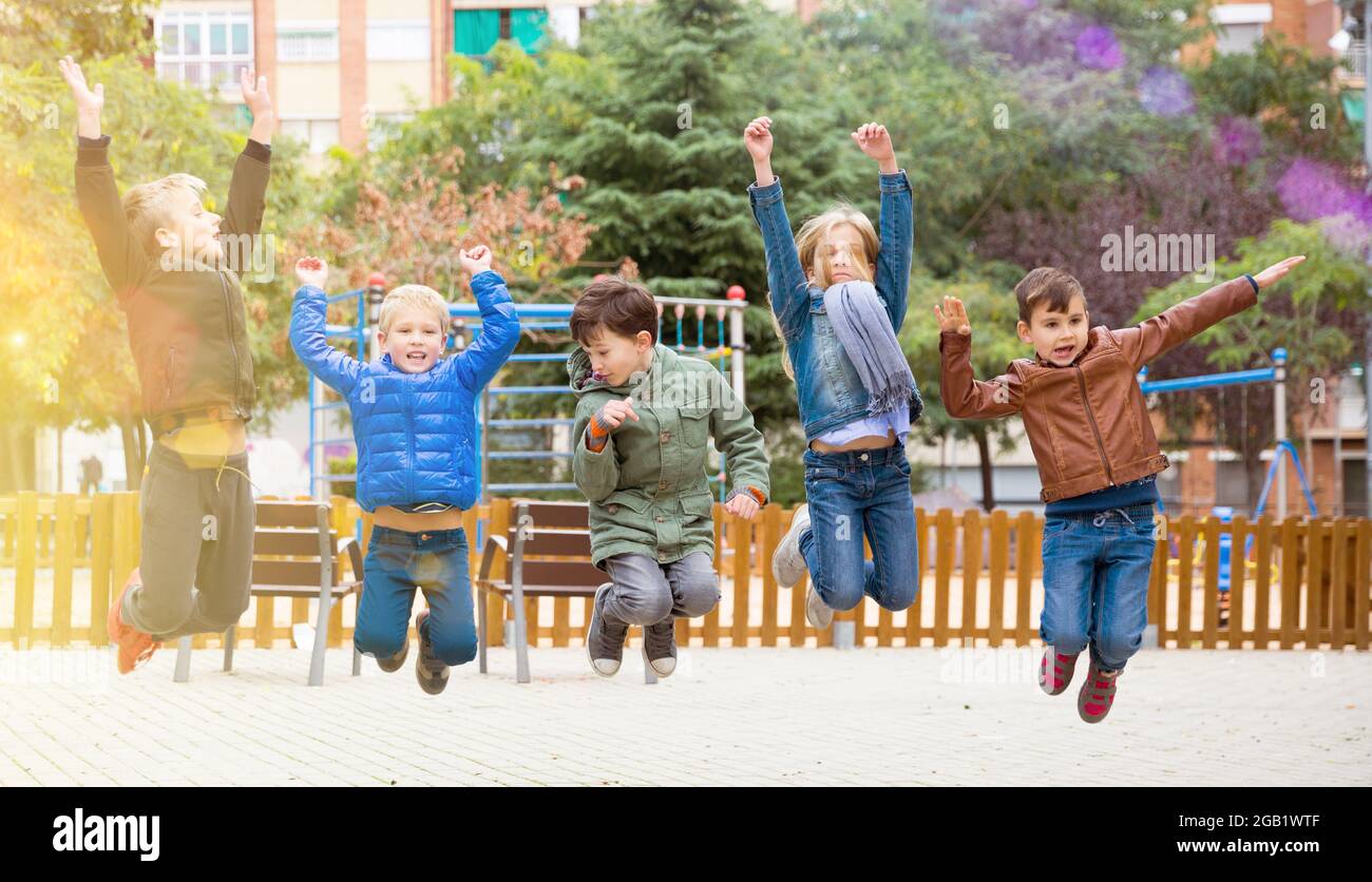 Happy children jumping together Stock Photo - Alamy