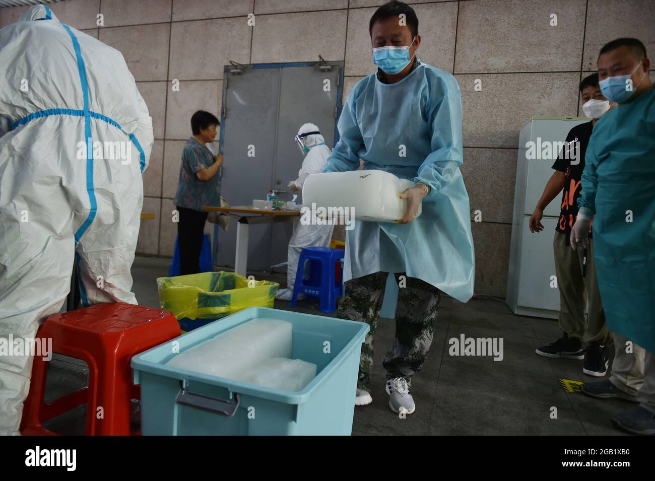 NANJING, CHINA - AUGUST 2, 2021 - Volunteers carry ice cubes to cool ...