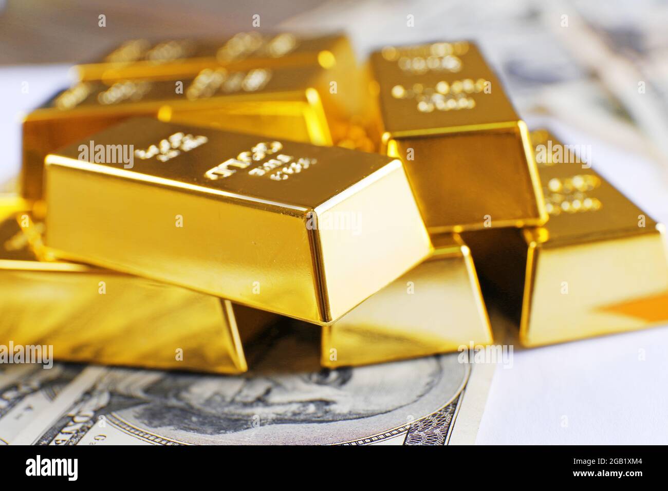 Gold bars with dollar banknotes on paper background Stock Photo - Alamy
