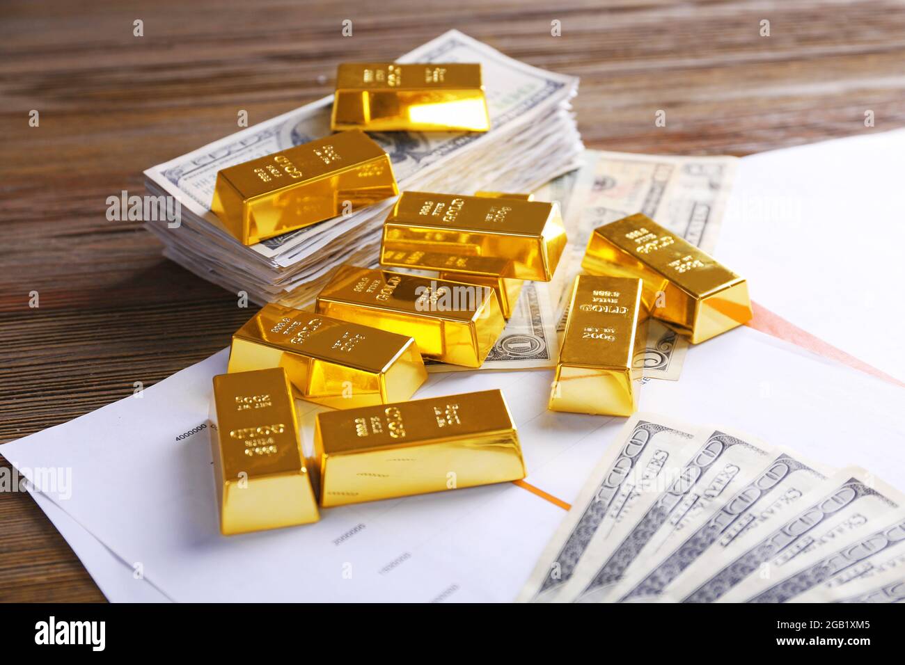 Gold bars with dollar banknotes on paper background Stock Photo - Alamy
