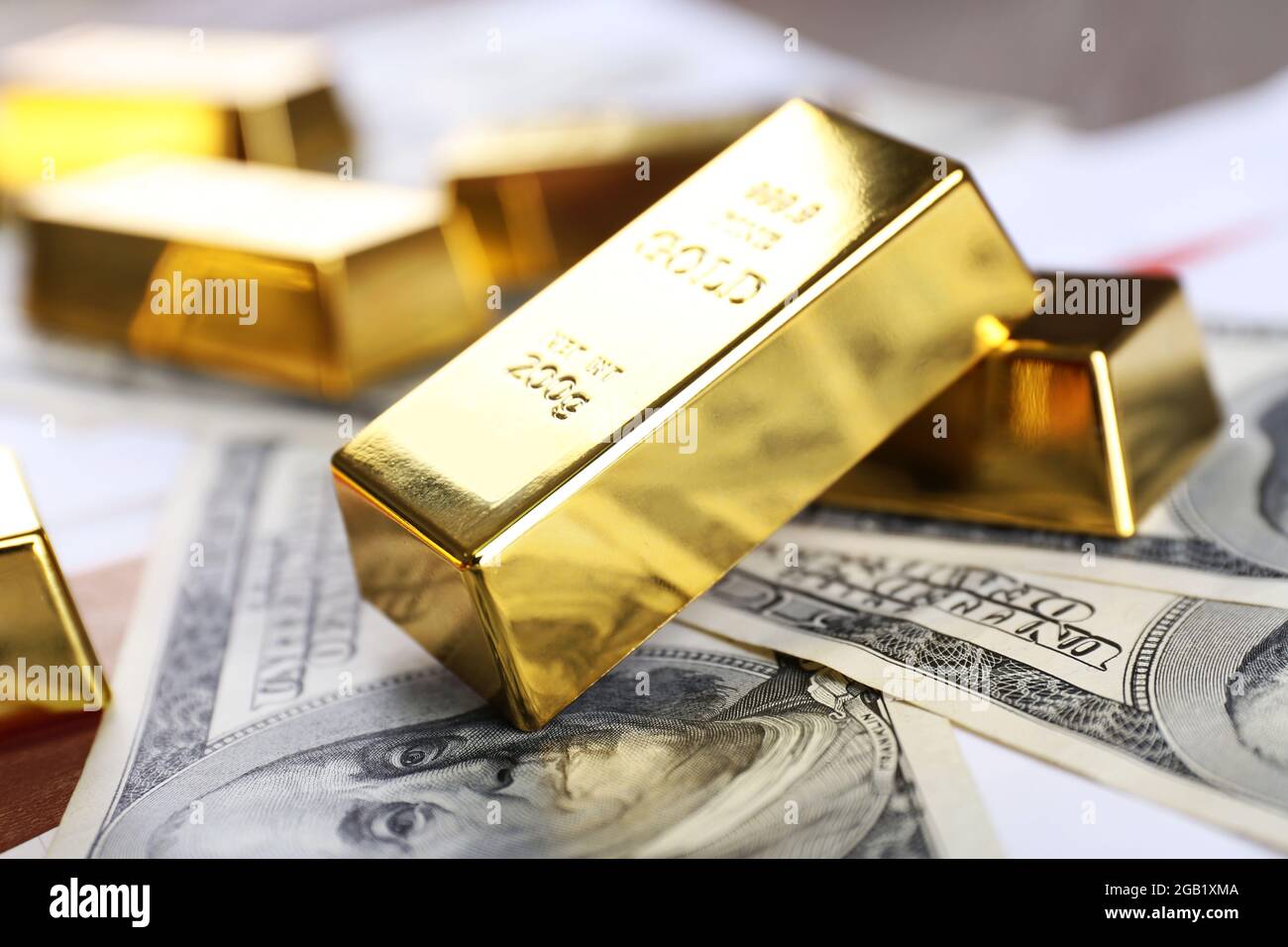 Gold bars with dollar banknotes on paper background Stock Photo - Alamy