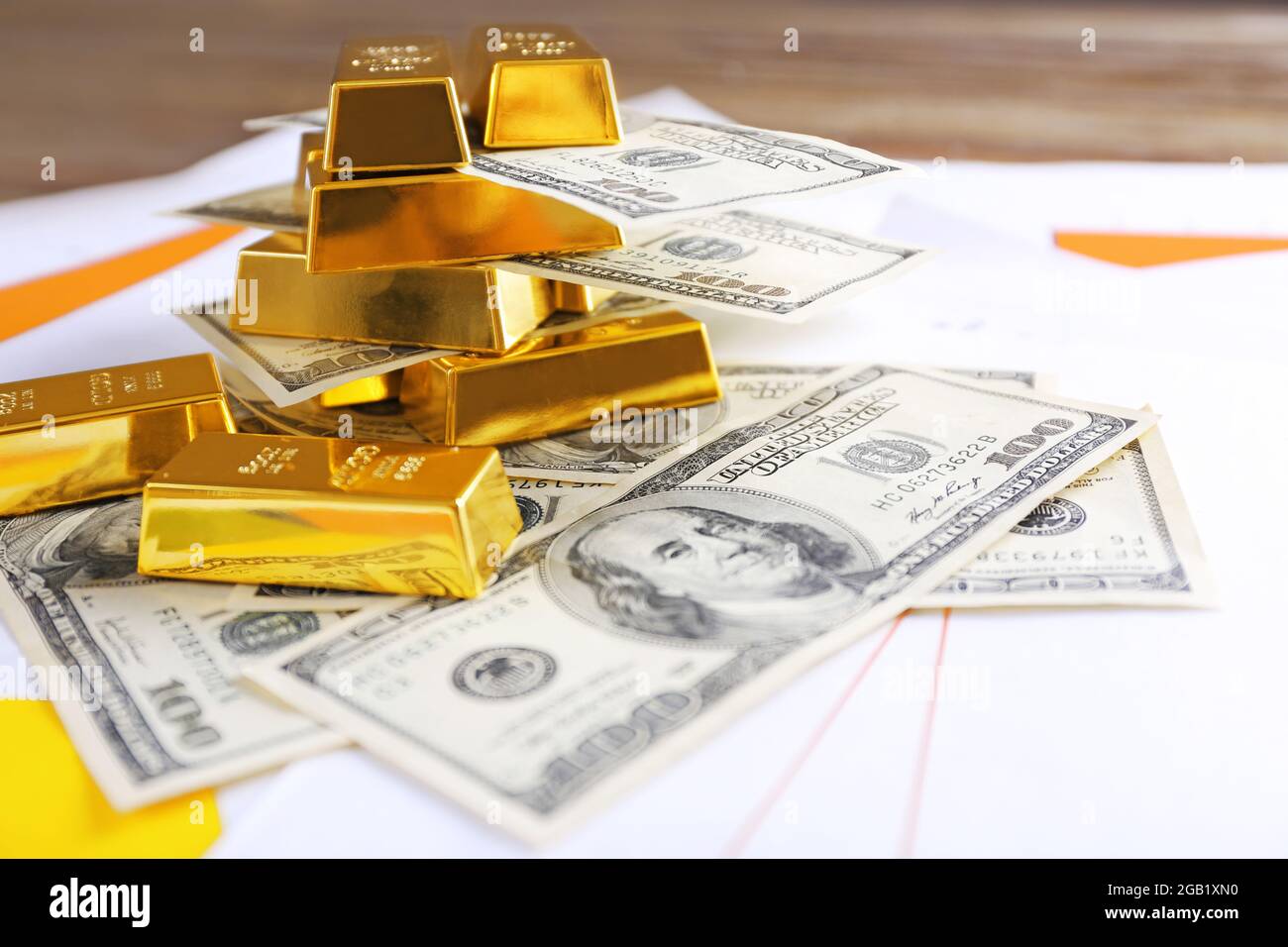 Gold bars with dollar banknotes on paper background Stock Photo - Alamy