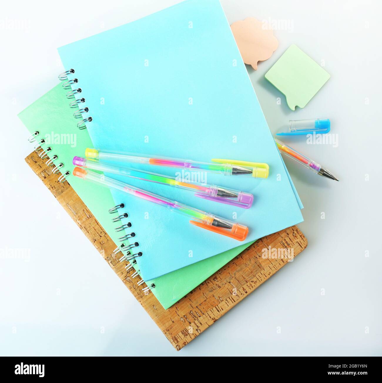 A pile of notebooks and stationary, isolated on white background Stock ...