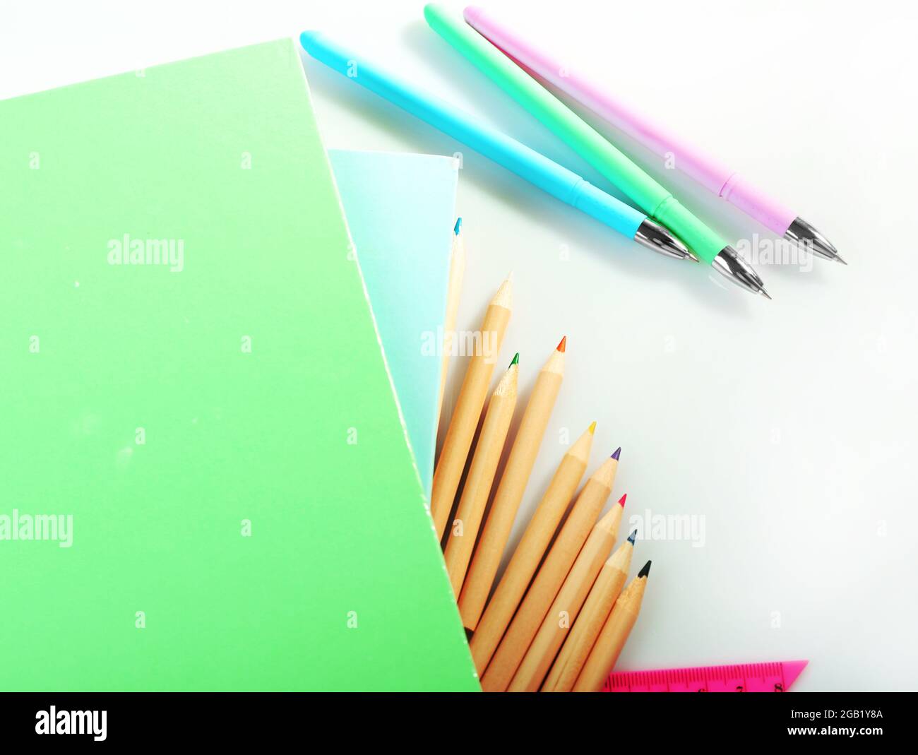 A pile of notebooks and stationary, isolated on white background Stock ...