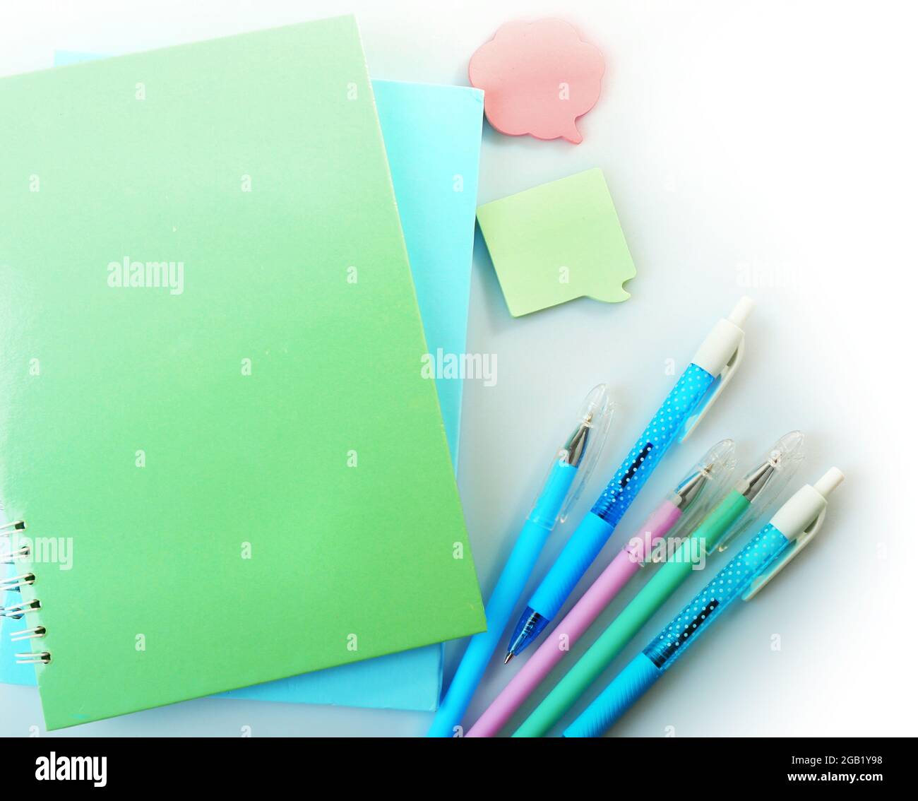 A pile of notebooks and stationary, isolated on white background Stock ...