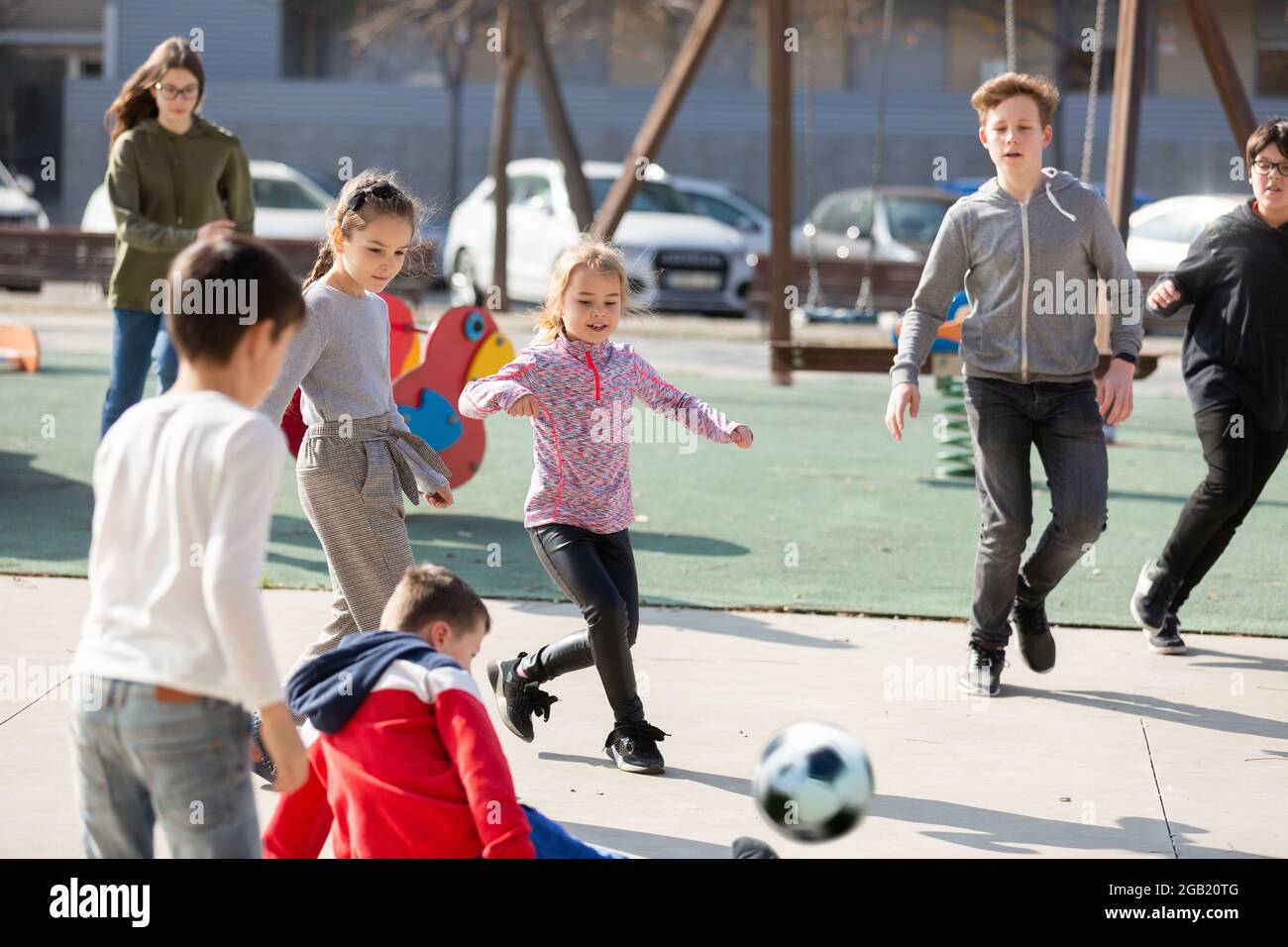 Kids running kicking soccer ball hi-res stock photography and images ...
