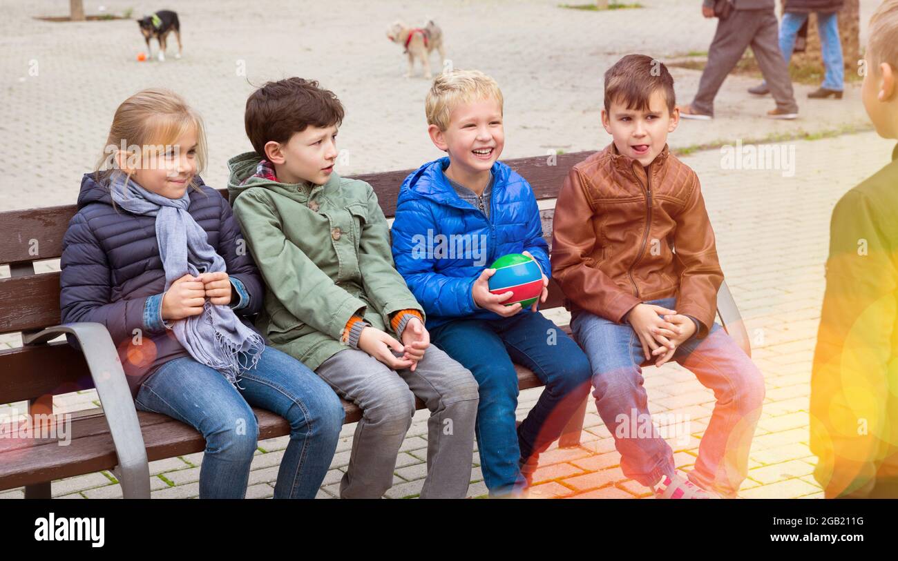 Children playing with ball on bench Stock Photo - Alamy
