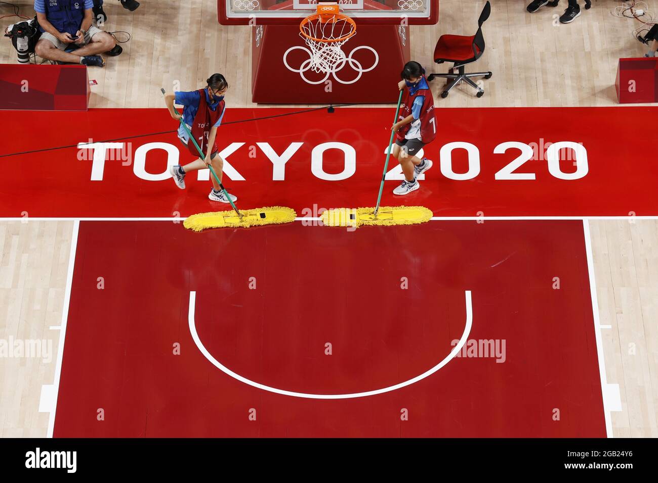 People mop the floor of a basketball court at Saitama Super Arena, the ...