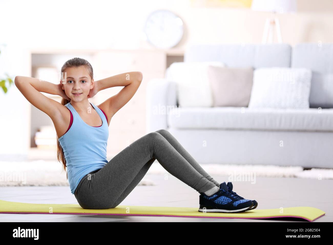Young girl making fitness exercise indoors Stock Photo - Alamy