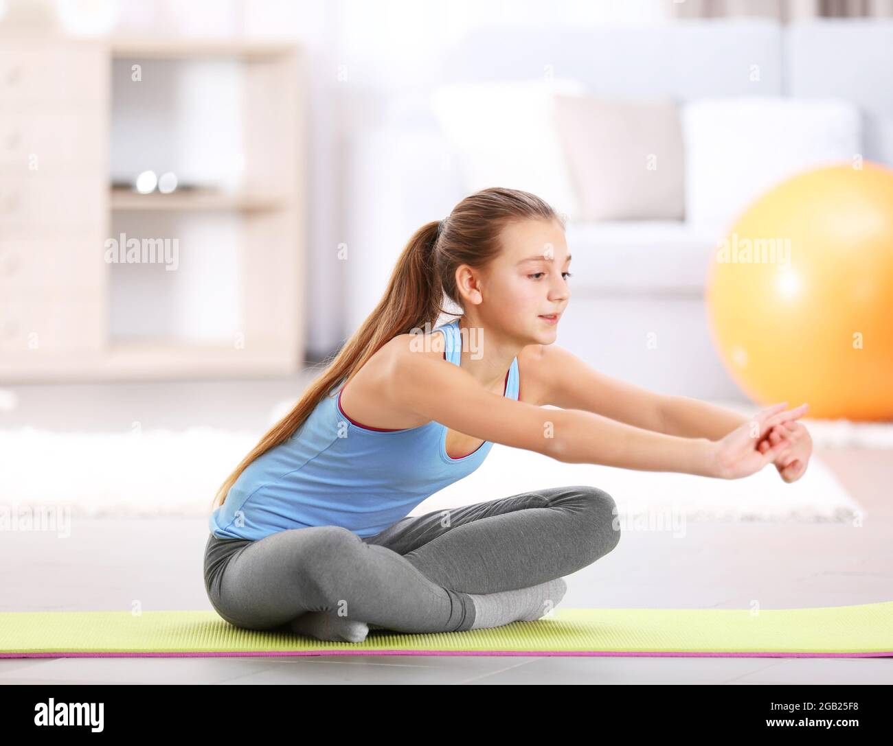 Young girl making fitness exercise indoors Stock Photo - Alamy