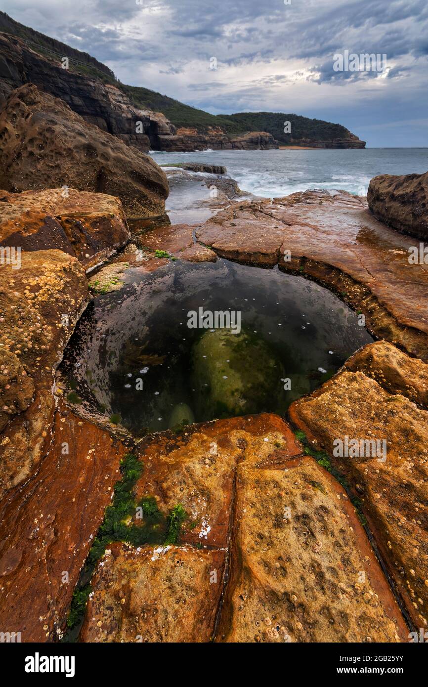 rockpool on the coastline with rocks leading to headland Stock Photo ...