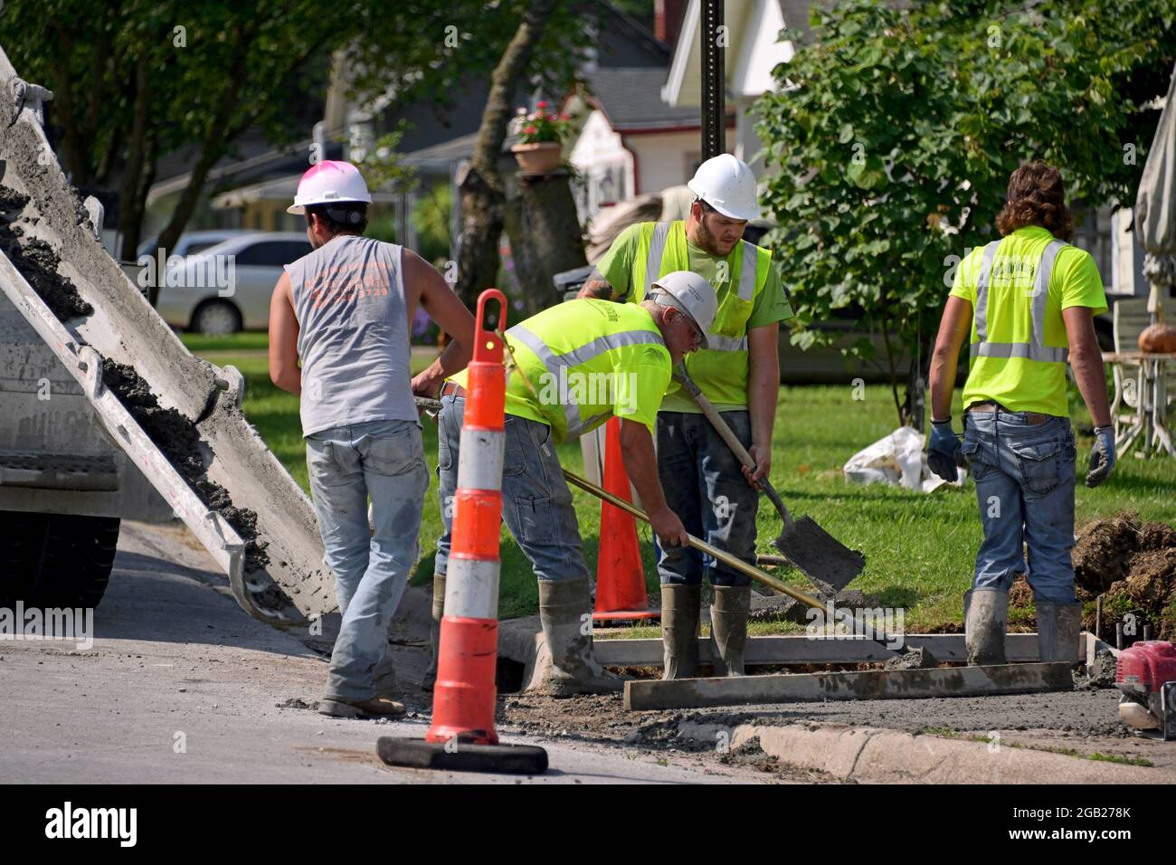 Concrete contractors working for the City of Emporia pour new concrete ...