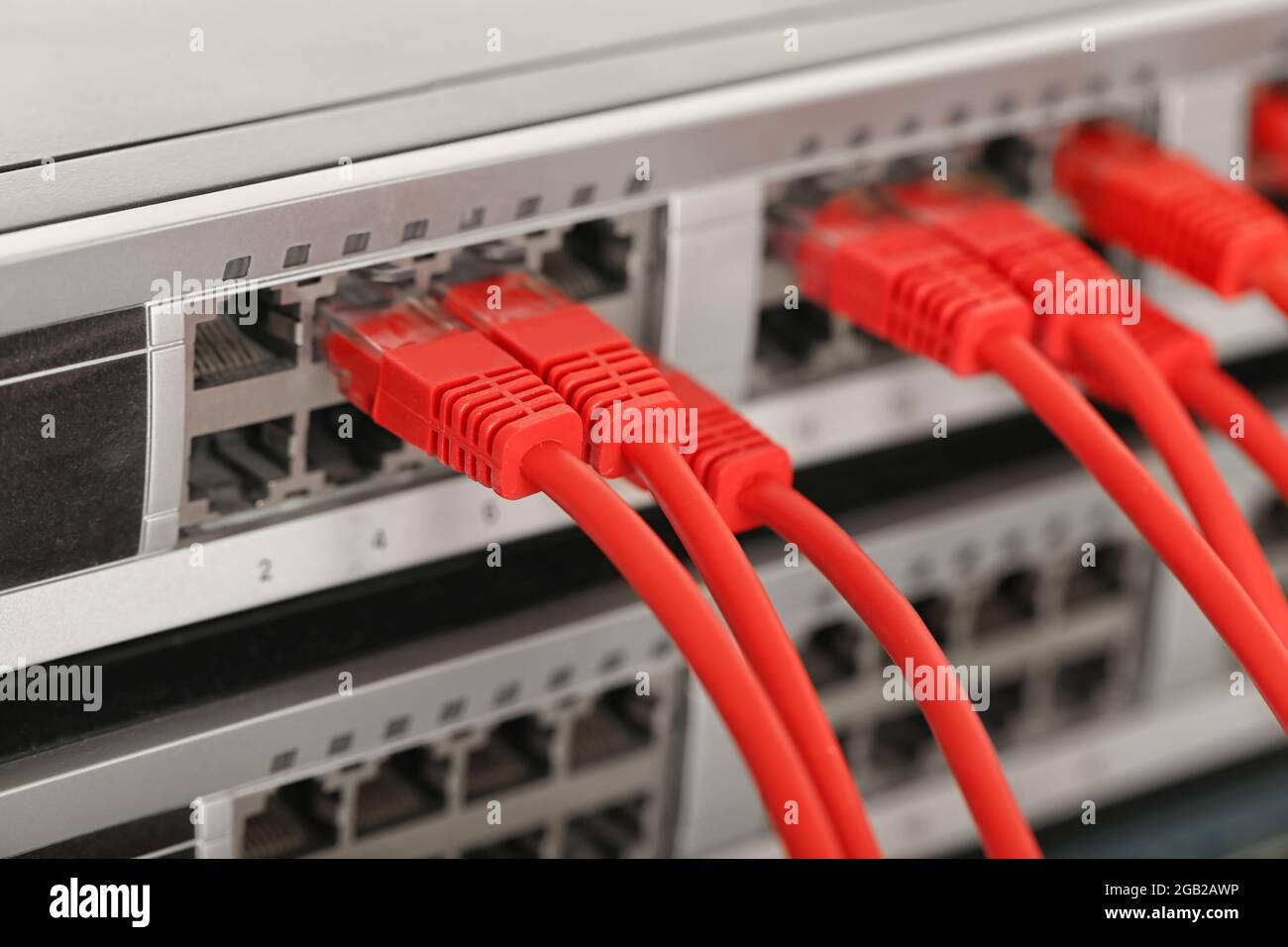 Red Ethernet cables connected to network switch, close up Stock Photo ...