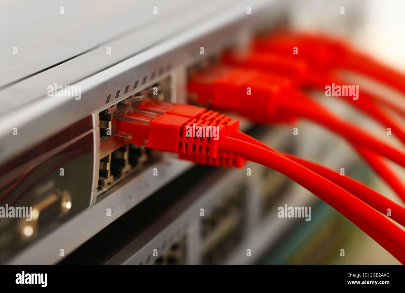 Red Ethernet cables connected to network switch, close up Stock Photo ...