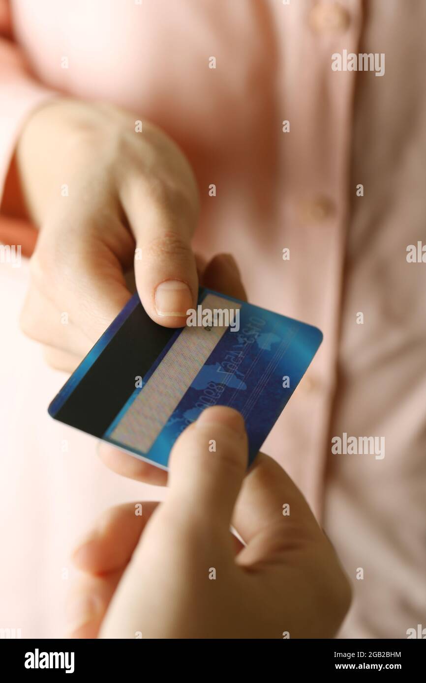 Hands holding blue credit card on white background Stock Photo - Alamy